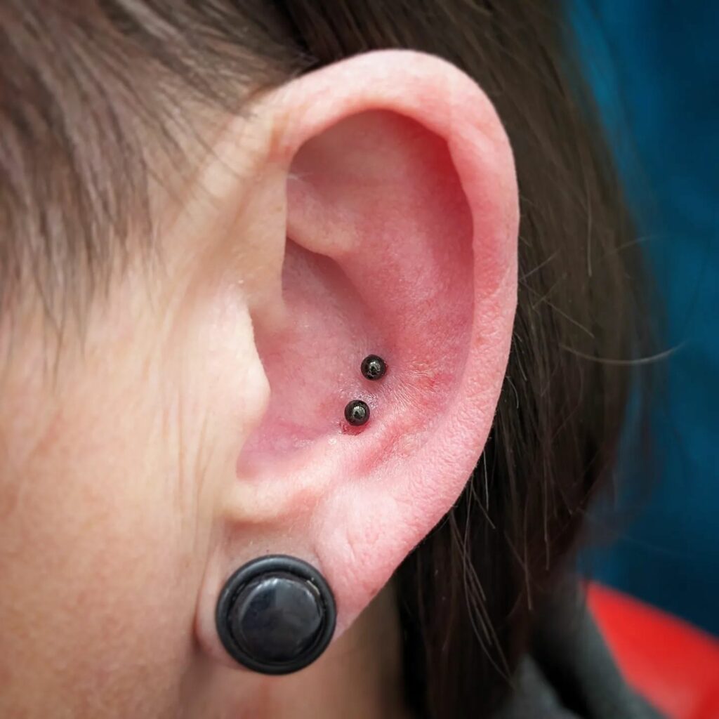 Double conch from today with black titanium studs. Placed to fit rings ...